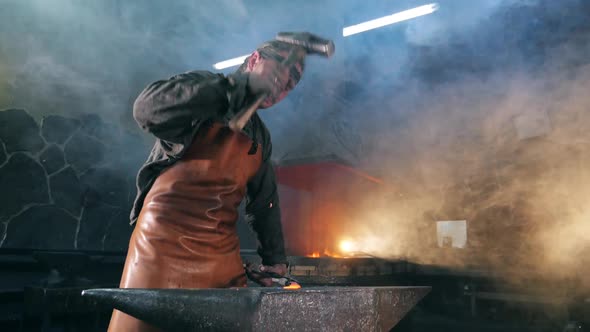 Hammersmith Is Beating Iron with a Hammer in Slow Motion, Stock Footage