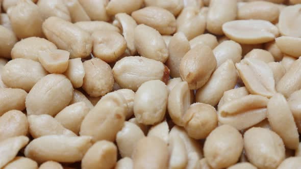 Groundnut roasted and salted on pile slow tilting food background 4K ...