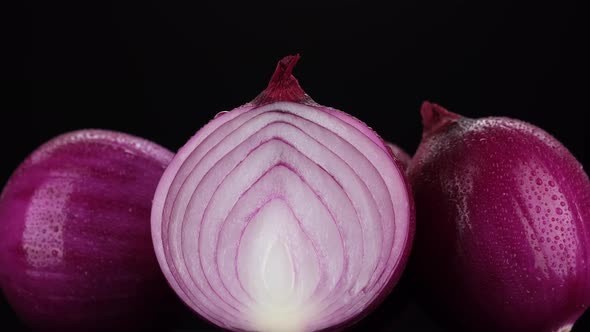 Purple Onions. Whole and slice purple onion on black background, rotate ...