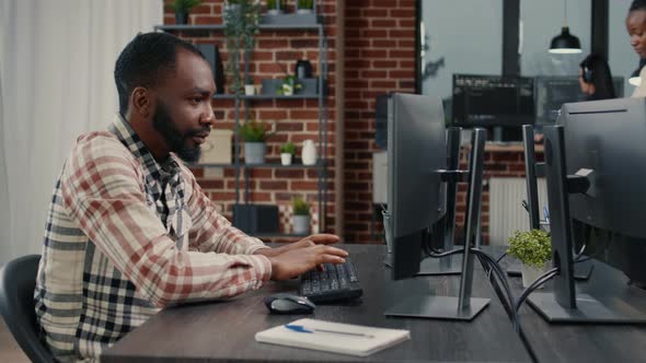 Software Developer Typing Programming Code On Computer Keyboard Turning Head And Smiling Stock