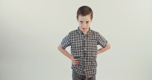 Young boy acting angry and mad on a white studio background, Stock Footage