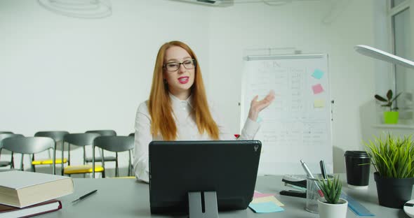 Woman Professor Sitting at Table and Lecturing Online at Class, Stock ...