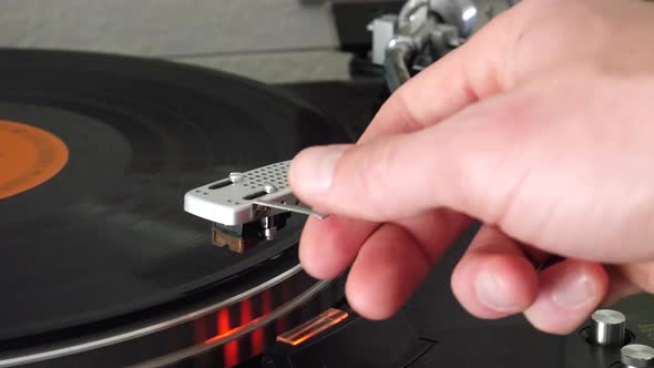 A record player spinning as the needle drops slowly onto the vinyl and ...