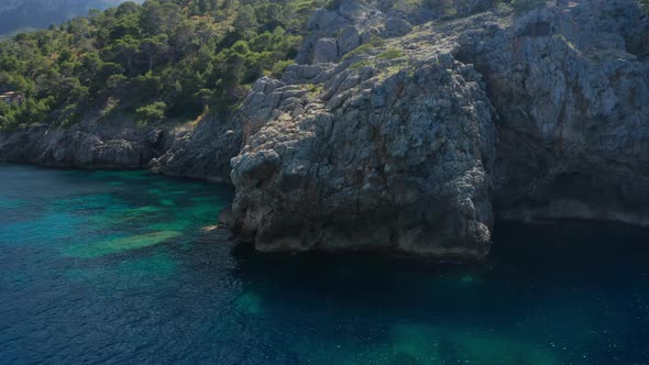 Drone Arcing Around Rocky Cliff Coastline And Blue Sea Of Ibiza, Stock ...