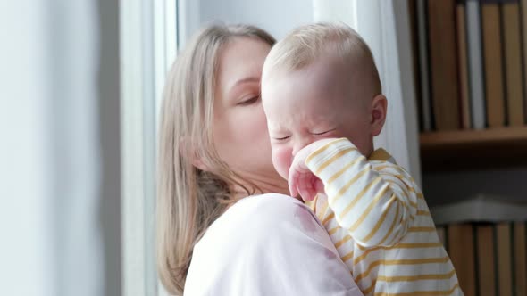 Mom Hugging and Soothing Her Crying Baby Little Infant Child Crying ...