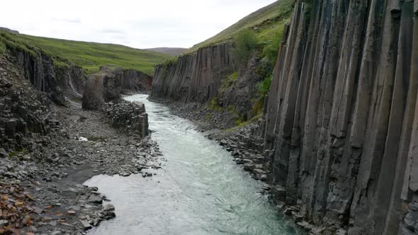 River Flowing Between Columnar Basalt Rock Formations Of Studlagil In ...