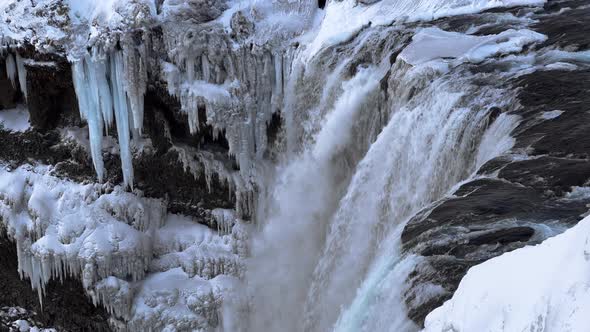 Slow motion shot of giant deluge of water flowing down icy waterfall in ...