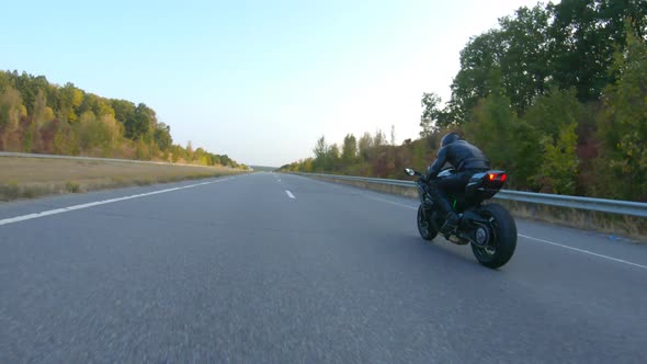 Follow To Biker Riding on Modern Sport Motorbike at Autumn Highway ...