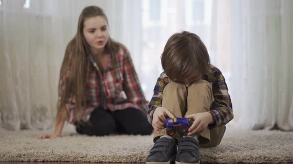 Portrait Older Sister Scolds Younger Brother Who Is Playing with the ...