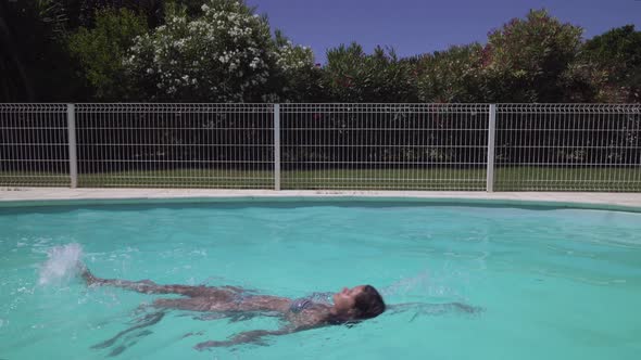 Woman swimming backwards in outdoor swimming pool, Stock Footage ...