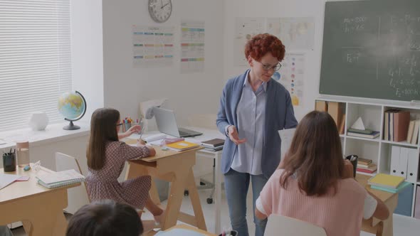 Teacher Collecting Assignments in Class, Stock Footage | VideoHive