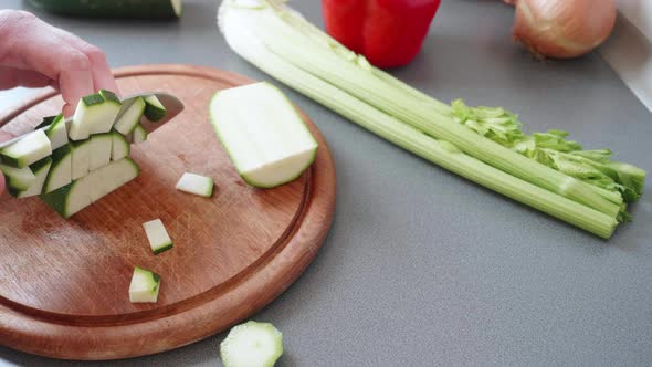 Slow motion of cutting a courgette into cubes., Stock Footage | VideoHive