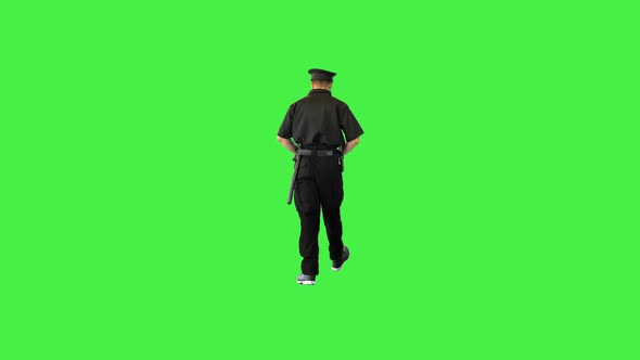Policeman in Uniform Walks Looking Around on a Green Screen Chroma Key ...