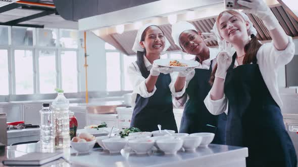 Group of schoolgirls having fun learning to cook. Female students in a ...
