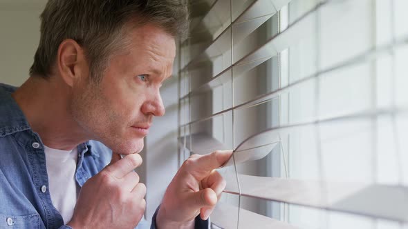 Man looking outside through the window 4k, Stock Footage | VideoHive