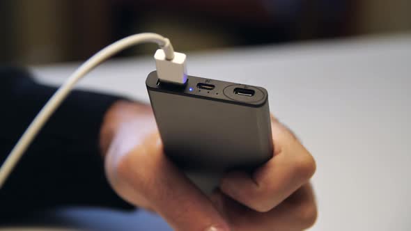 Inserting a USB cable charger into portable power bank, Stock Footage