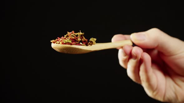 Pouring Spices From Wooden Spoon on Black Background Using Seasoning ...