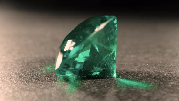 Rotating camera shots of isolated lying big green emerald. Treasure ...