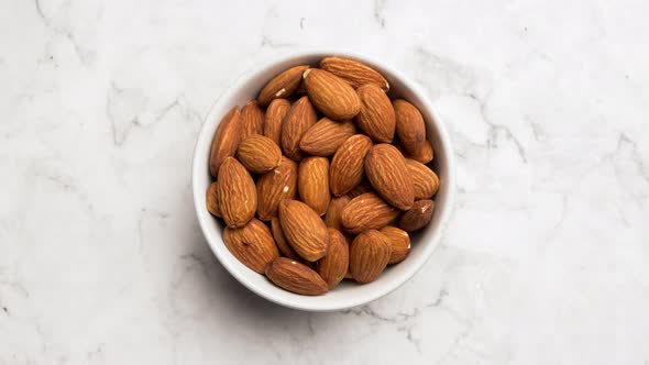 Top view Stop motion animation Almonds nuts in a white bowl., Stock Footage