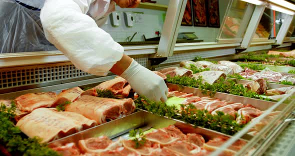 Butcher arranging meat in refrigerator, Stock Footage | VideoHive