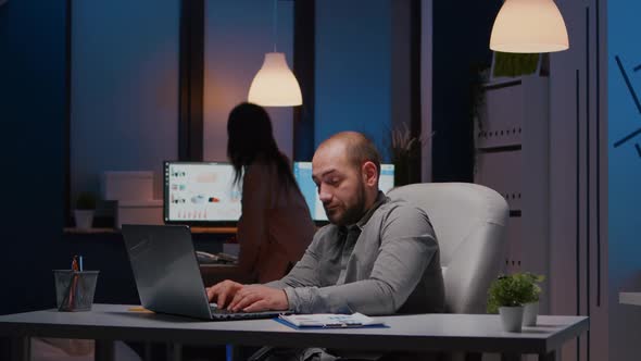 Overworked Businessman Typing Management Strategy on Laptop Working in ...