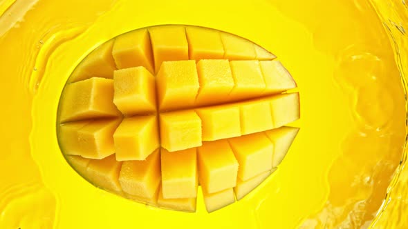 Super Slow Motion Shot of Mango Falling and Splashing Into Water on ...