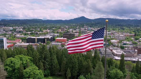 American Flag waving in aerial view of Eugene Oregon, Stock Footage