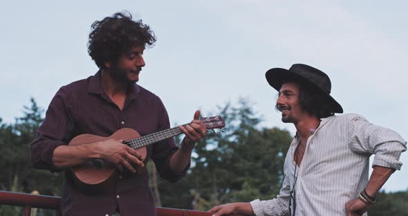Two handsome musicians playing guitar and singing, Stock Footage ...