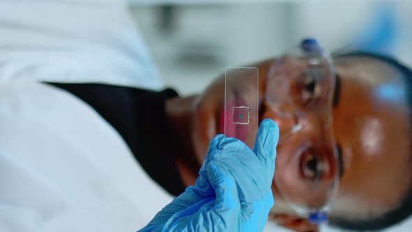 Vertical Video Black Lab Technician Doing Experiment in Lab Looking at ...