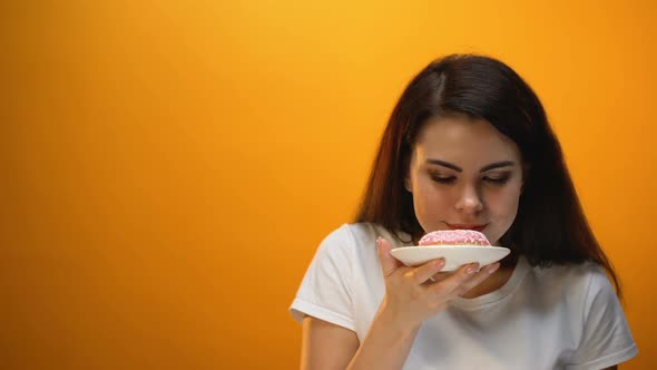 Happy Girl Smelling and Showing Donut to Camera, Sweetened Snack ...