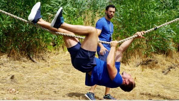 Man crossing the rope during obstacle course 4k by Wavebreakmedia ...