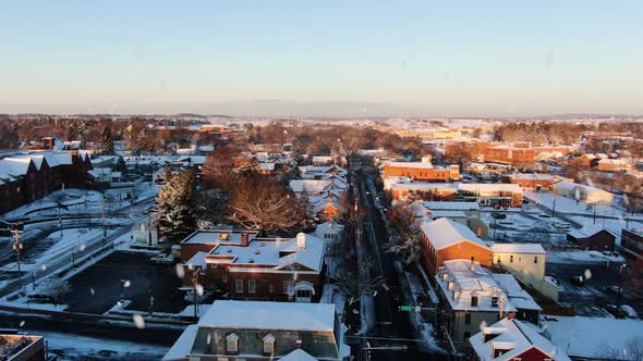 AERIAL Dolly Back Downtown Lititz During Snowfall At Sunset, Stock Footage