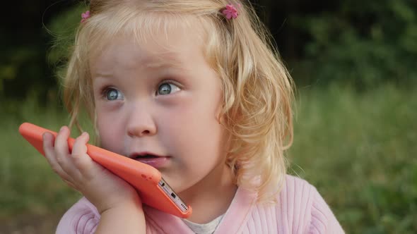 Cute Little Girl Calls By Mobile Phone and Fun Talks, Stock Footage