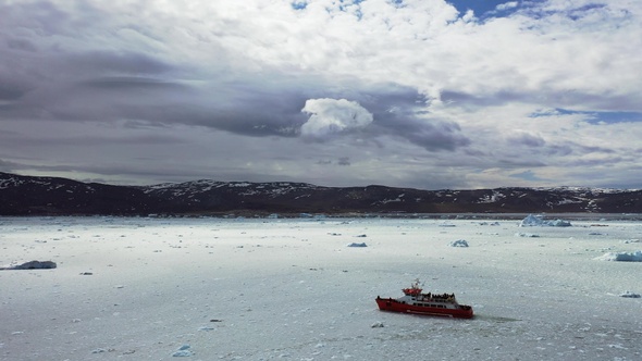 Environment. Cruise ship surrounded by icebergs and ice. Aerial view ...