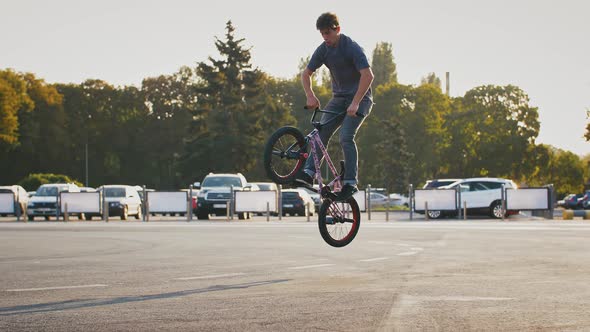Male Bmx Rider is Bouncing and Spinning Handlebars of His Bike on Its ...