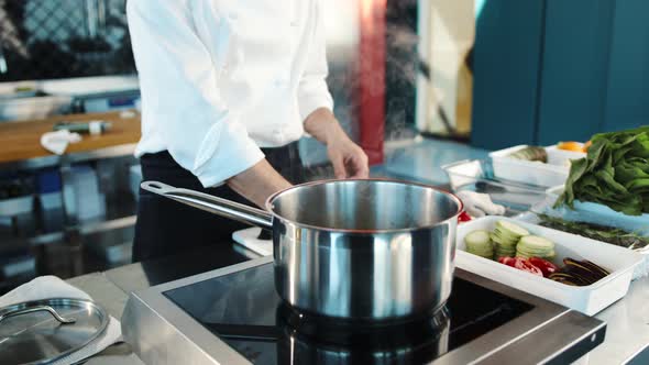 Close-up: The chef adds ingredients to the pot. The process of ...