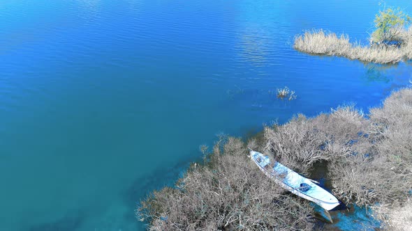 Aerial view moving fishing boat at the lake. Top view sailing fishing ...