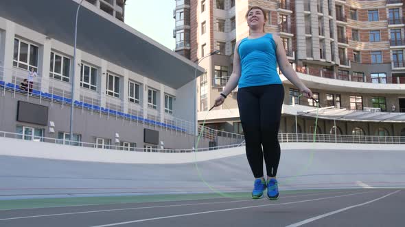 Overweight Female Jumping Rope on Sports Ground, Stock Footage | VideoHive