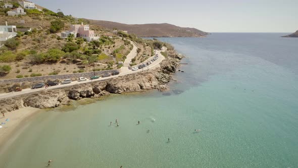 Aerial view of people swimming on beach, Alithini, Syros island in ...