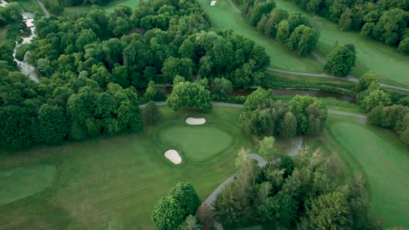 Aerial birds-eye view of golf course fairway and putting green, natural ...