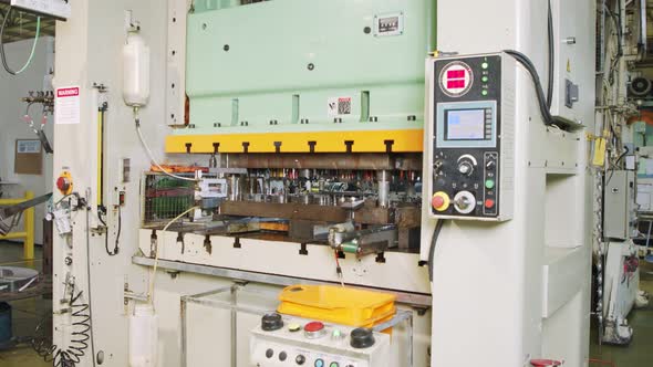 A large industrial punch press forming sheet metal parts, Stock Footage