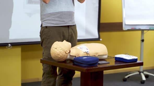 Training for safe life of child. Demonstrating chest compression on ...