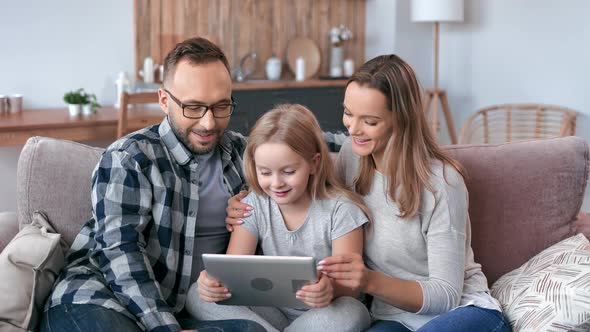 Happy Family Use Tablet Browsing Internet Spending Time Together ...