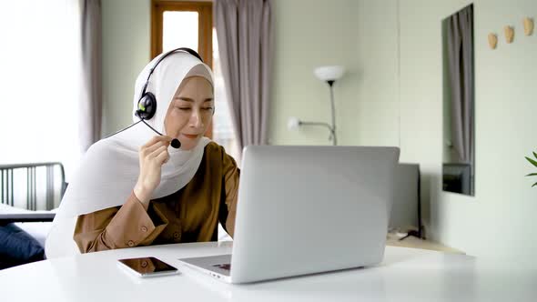 Portrait of muslim operator business woman working with headset and ...