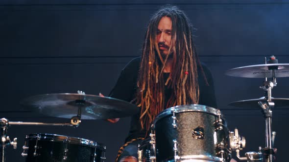 Talented Musician with Dreadlocks Play on Drums in Smoke in a Club ...