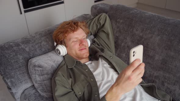 Side View Young British Ginger Man in Headphone Talking on Video Call ...