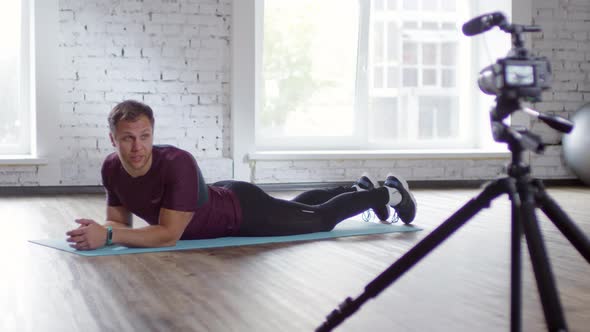 Male Coach Recording Video with Trunk Lift Exercise, Stock Footage