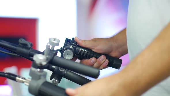 A man operates the focus and zoom controls on a professional studio ...