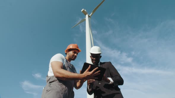 Engineer and Inspector Working Together on Windmill Farm, Stock Footage
