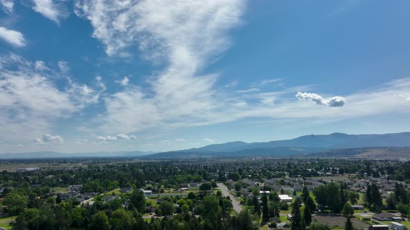 Wide drone shot of expansive Spokane neighborhoods with a bright blue ...